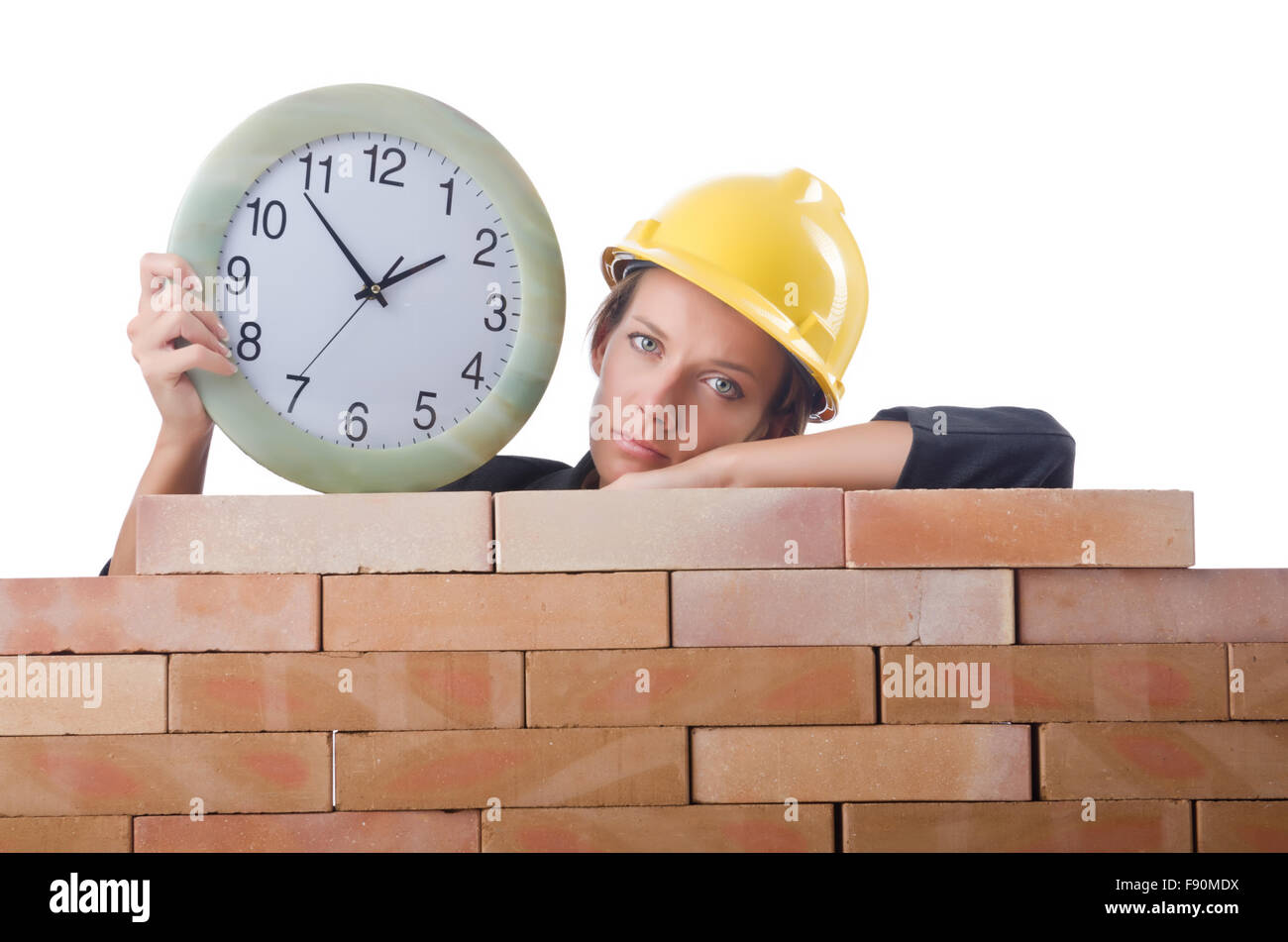 Woman construction worker with clock on white Stock Photo - Alamy