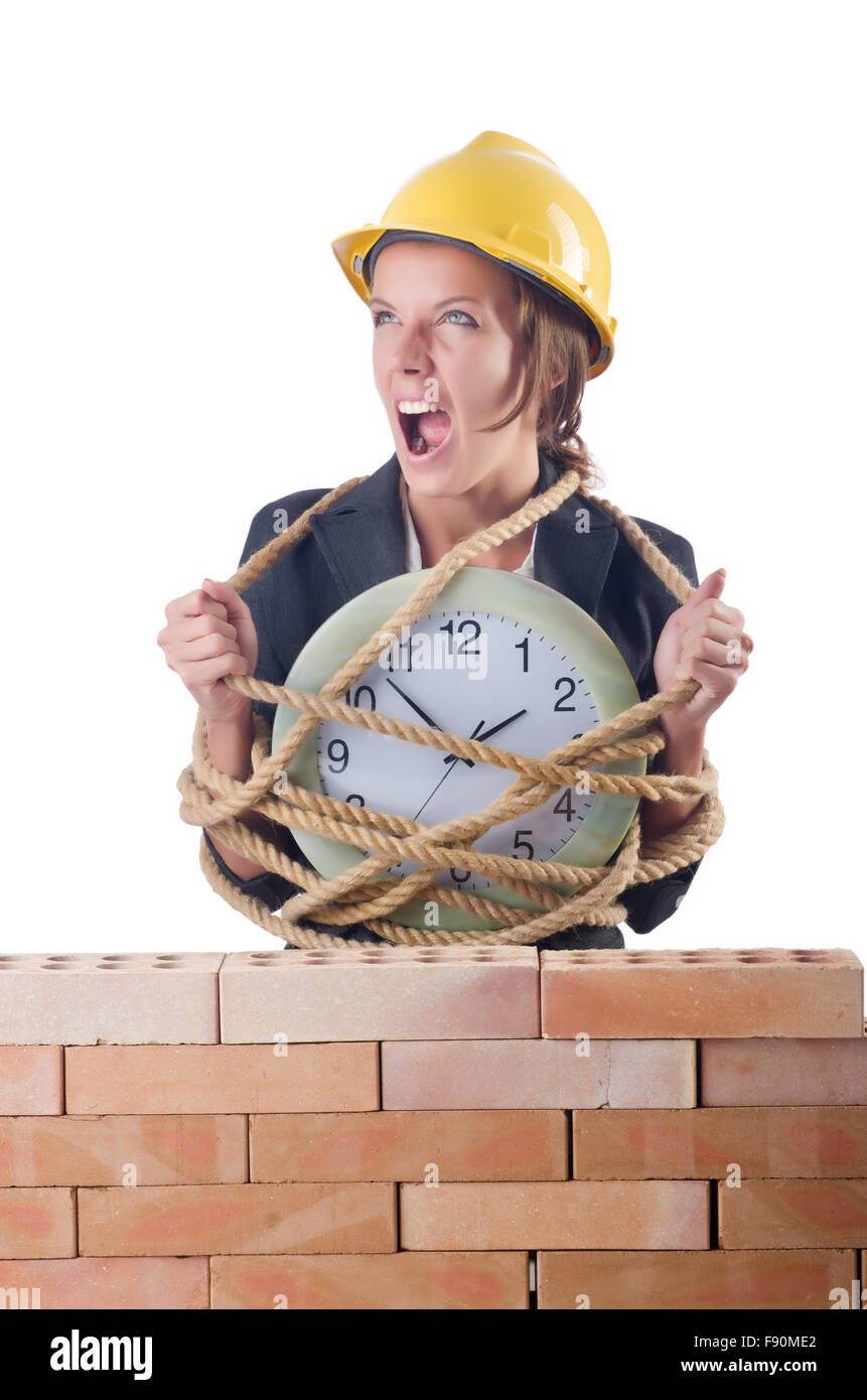 Woman construction worker with clock on white Stock Photo - Alamy