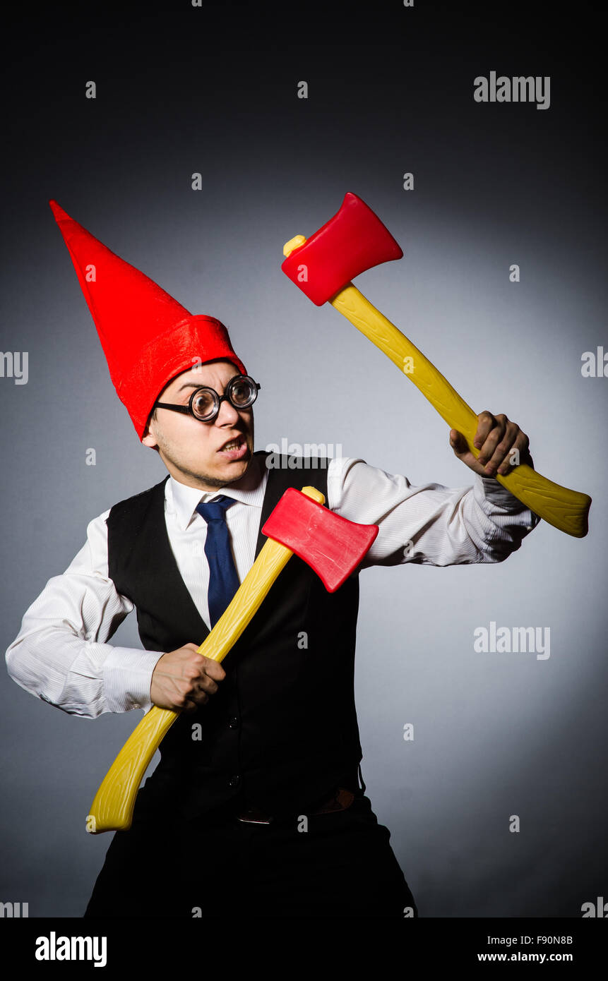 Man with axes in funny concept Stock Photo - Alamy