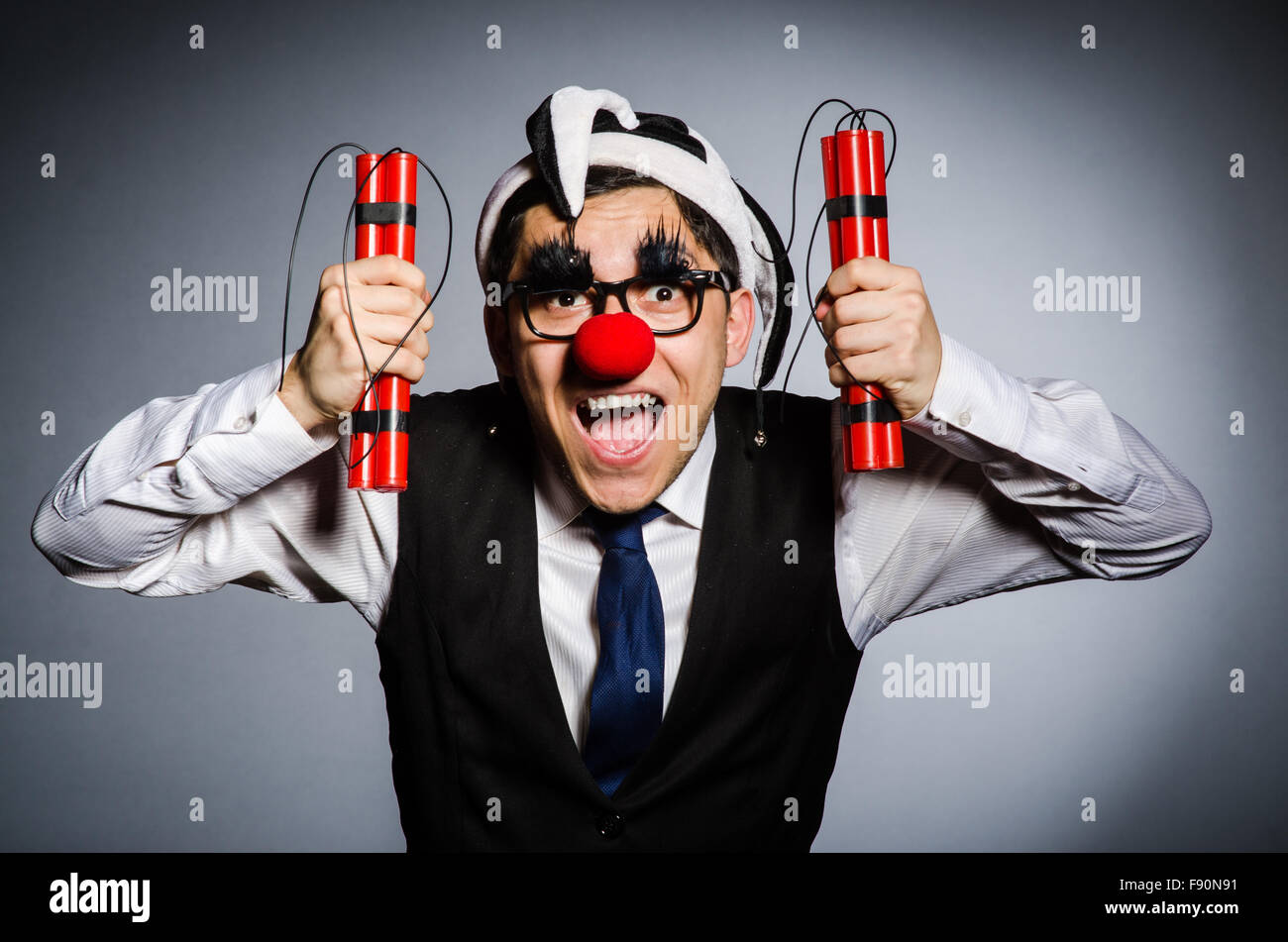 Funny clown with sticks of dynamite Stock Photo - Alamy