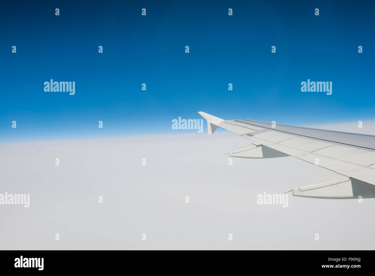 Airplane wing out of window Stock Photo - Alamy