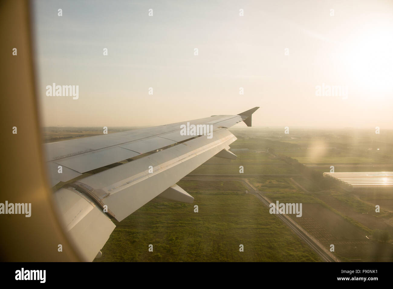 Airplane wing out of window Stock Photo - Alamy