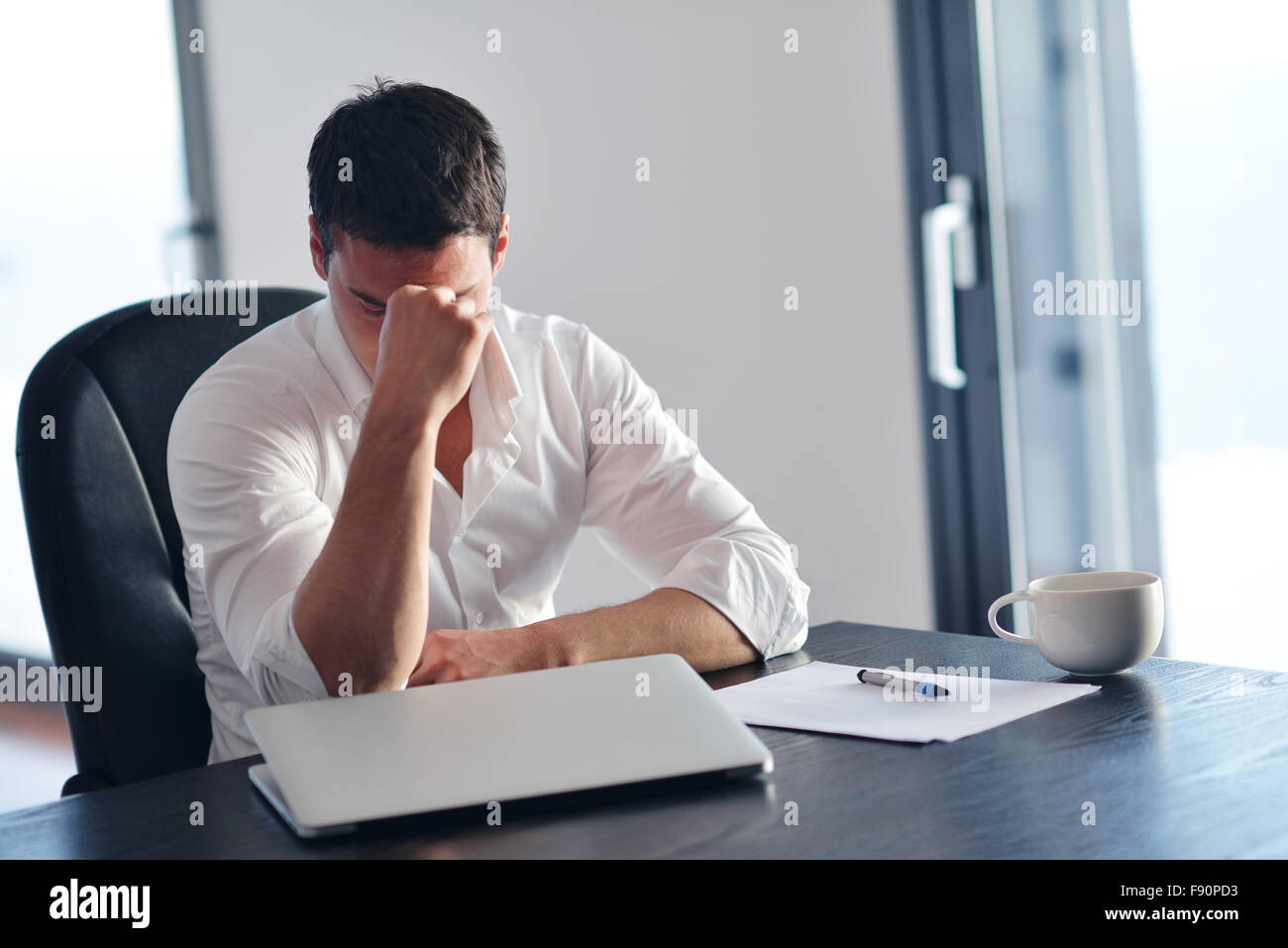 frustrated with problems young business man working on laptop computer ...