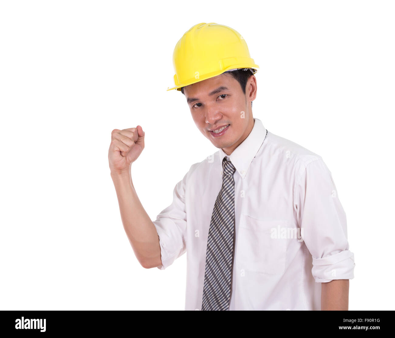Happy young engineer celebrating with arm raised, concept of successful ...