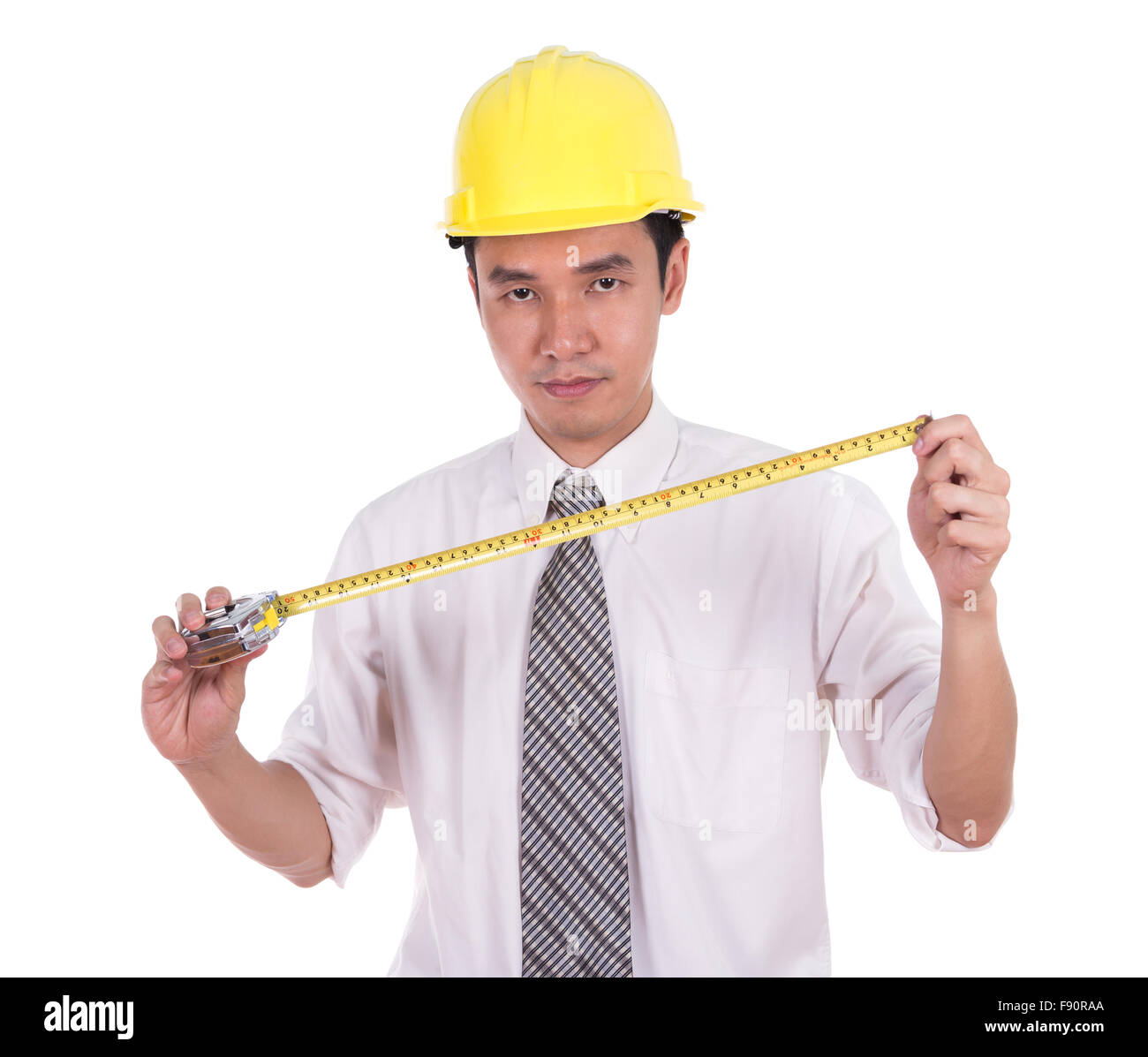 Construction worker is holding a tape measure hi-res stock photography ...