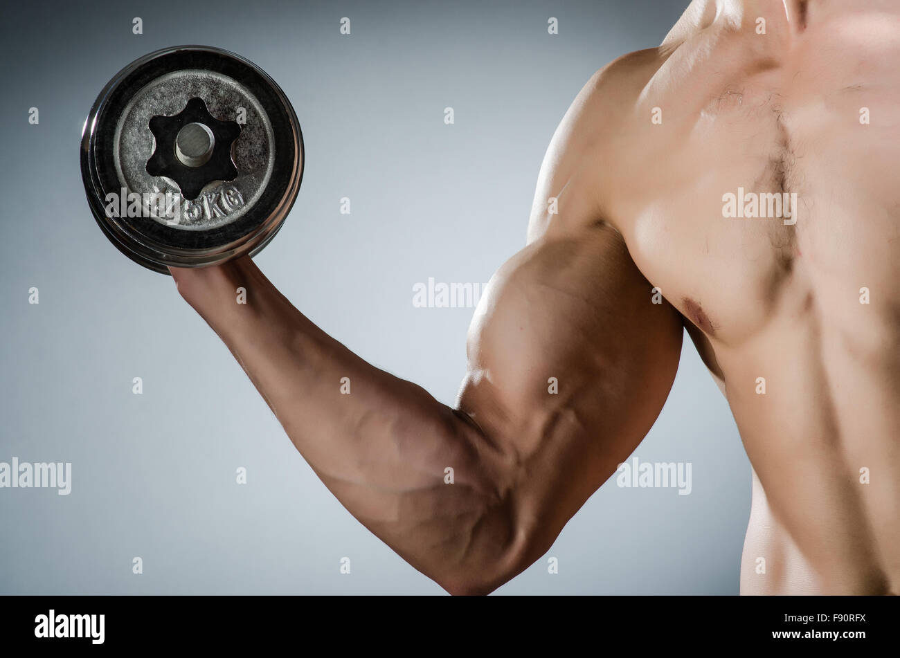Muscular ripped bodybuilder with dumbbells Stock Photo - Alamy
