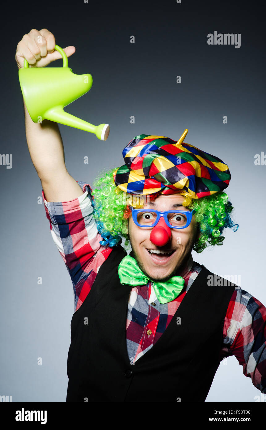 Funny clown with watering can Stock Photo - Alamy