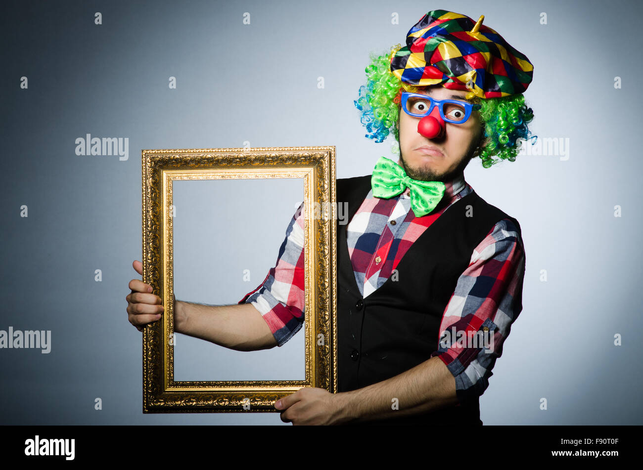 Funny clown with picture frame Stock Photo - Alamy