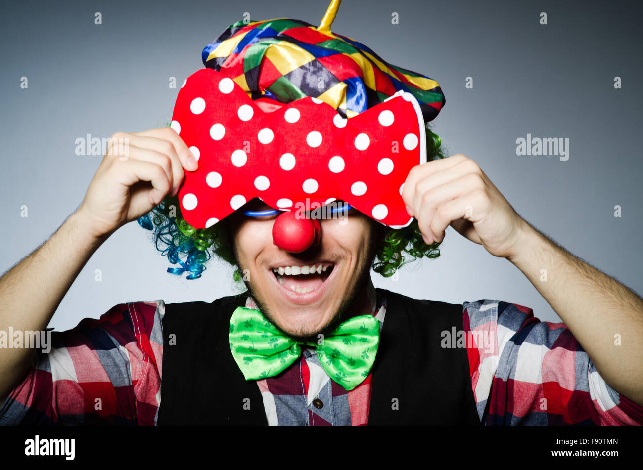 Funny clown against the dark background Stock Photo - Alamy