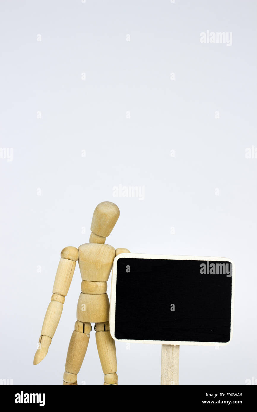 Wooden man with sign in front of white background Stock Photo - Alamy