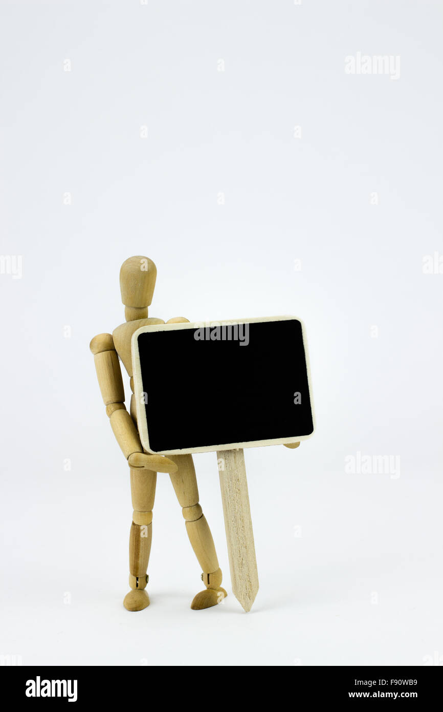 Wooden man with sign in front of white background Stock Photo - Alamy