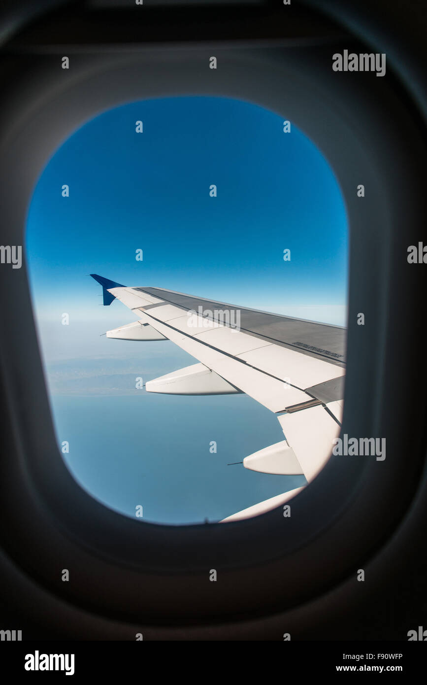 Airplane wing out of window Stock Photo - Alamy