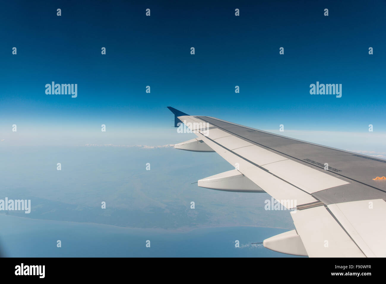 Airplane wing out of window Stock Photo - Alamy