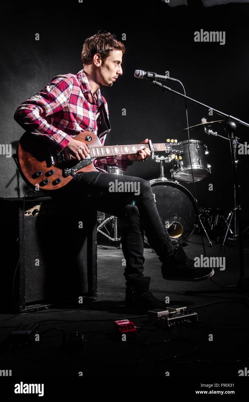 Man with guitar during concert Stock Photo - Alamy