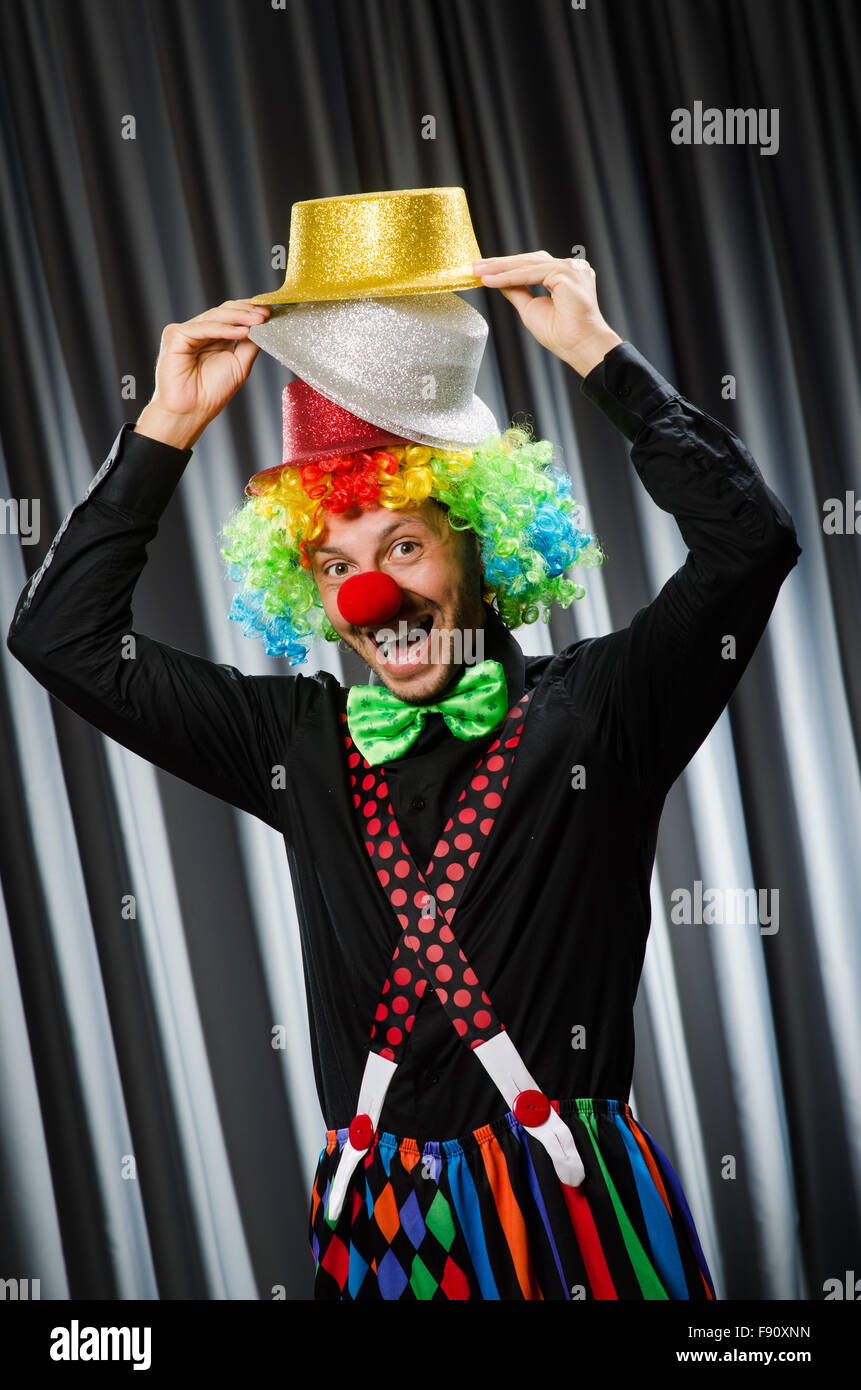 Funny clown in humorous concept against curtain Stock Photo - Alamy