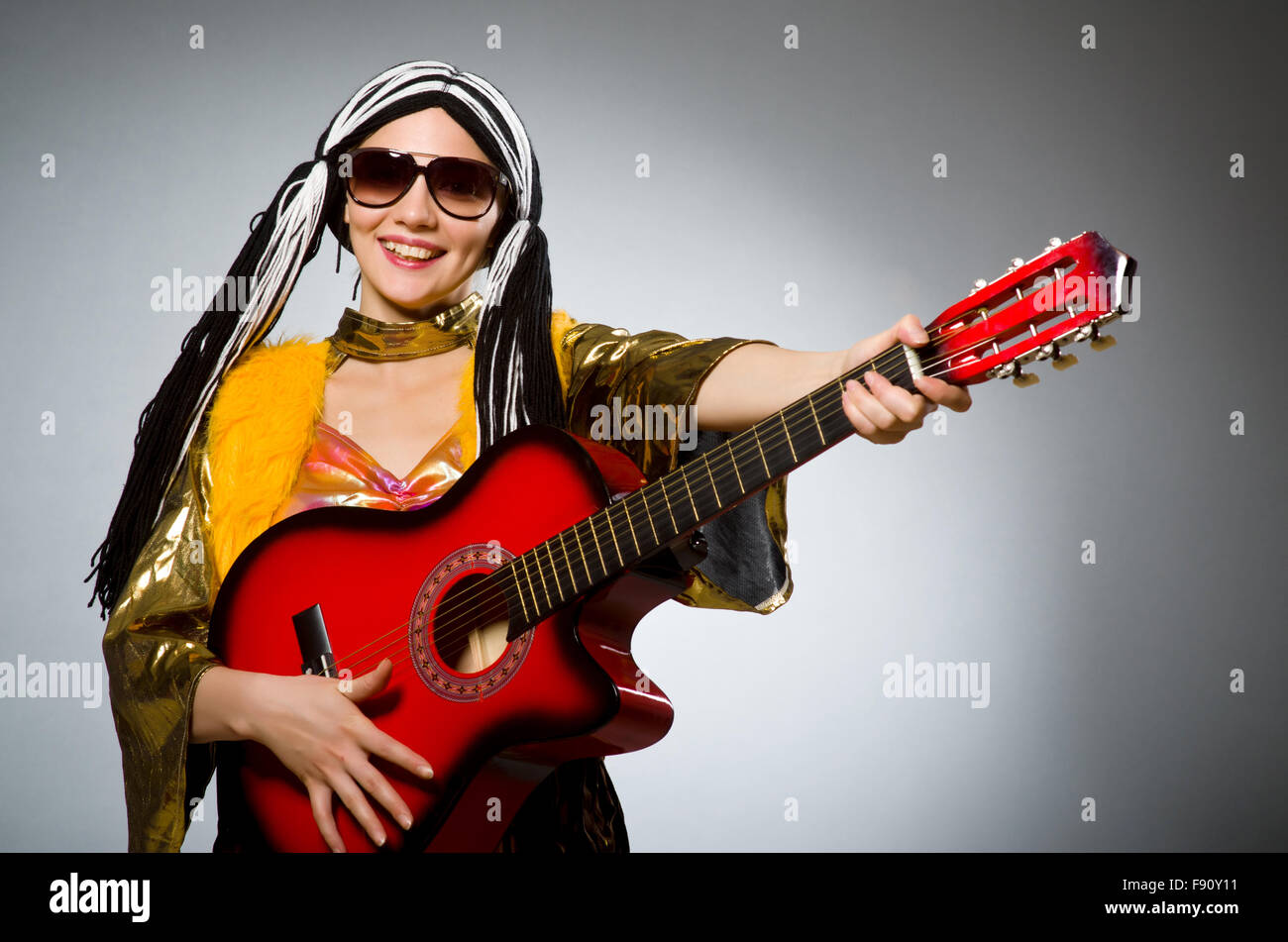 Guitar player with red instrument Stock Photo - Alamy