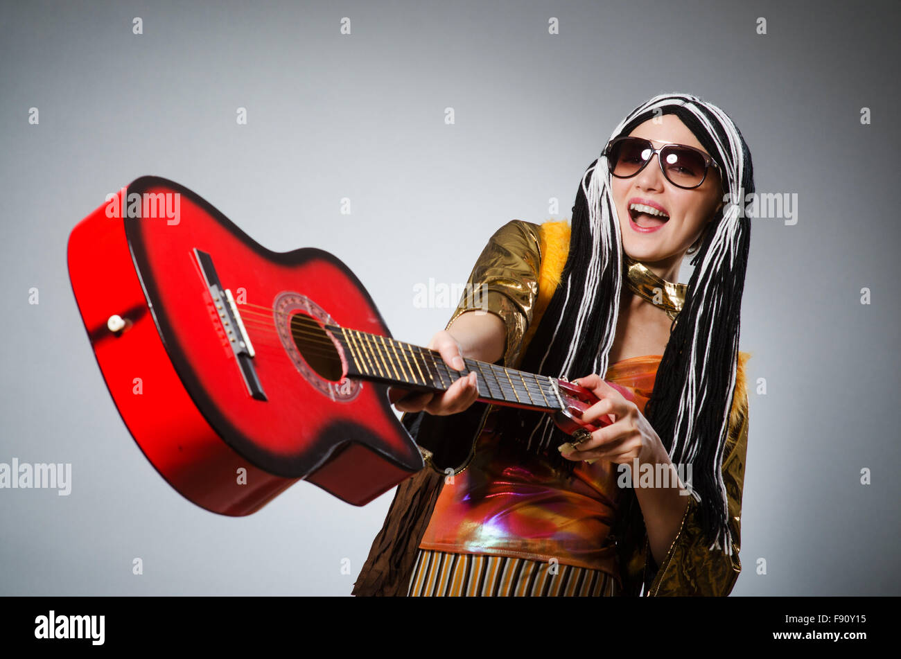 Guitar player with red instrument Stock Photo - Alamy