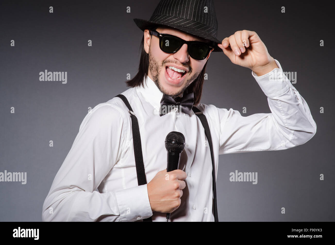 Funny singer with microphone at the concert Stock Photo - Alamy