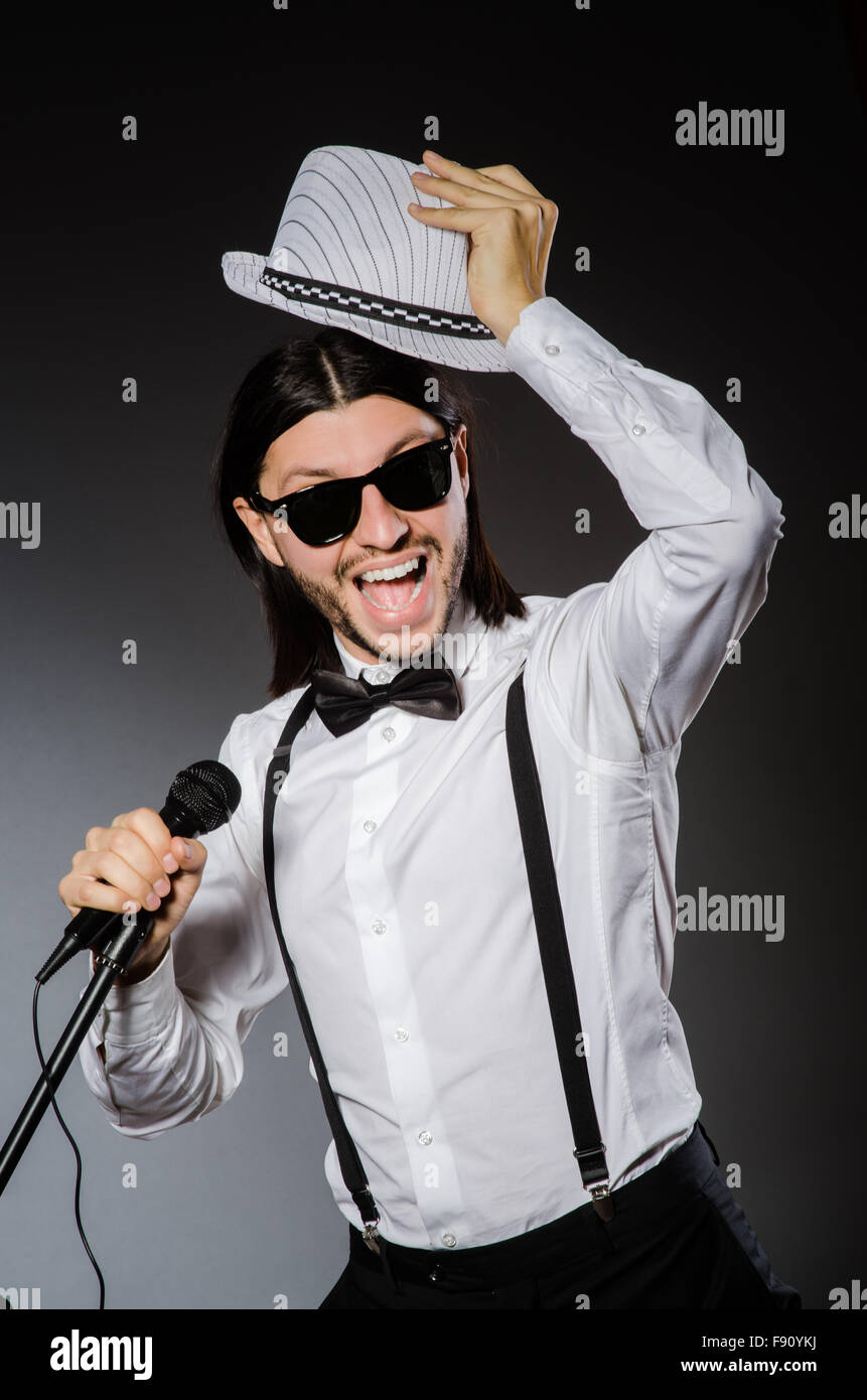 Funny singer with microphone at the concert Stock Photo - Alamy
