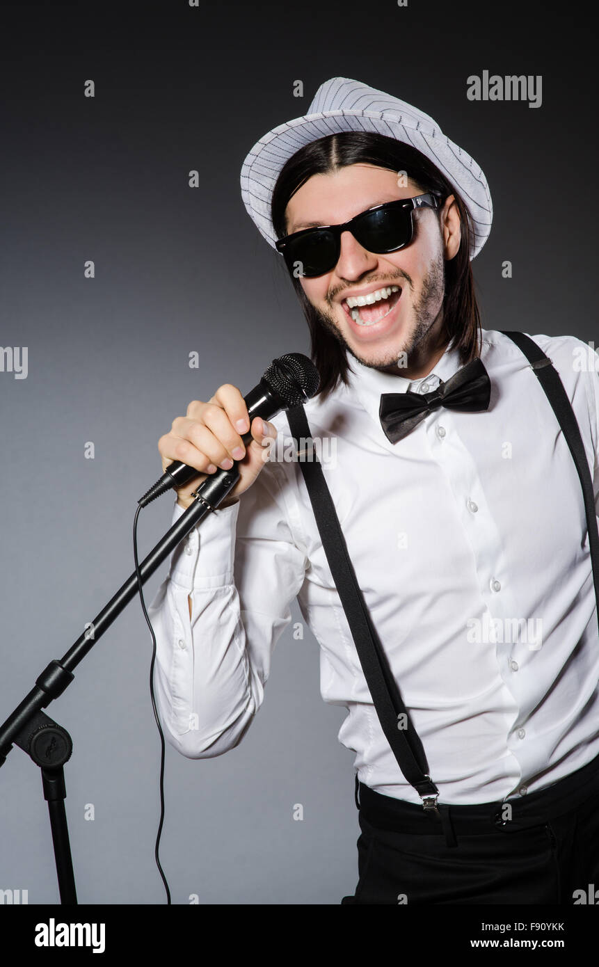 Funny singer with microphone at the concert Stock Photo - Alamy