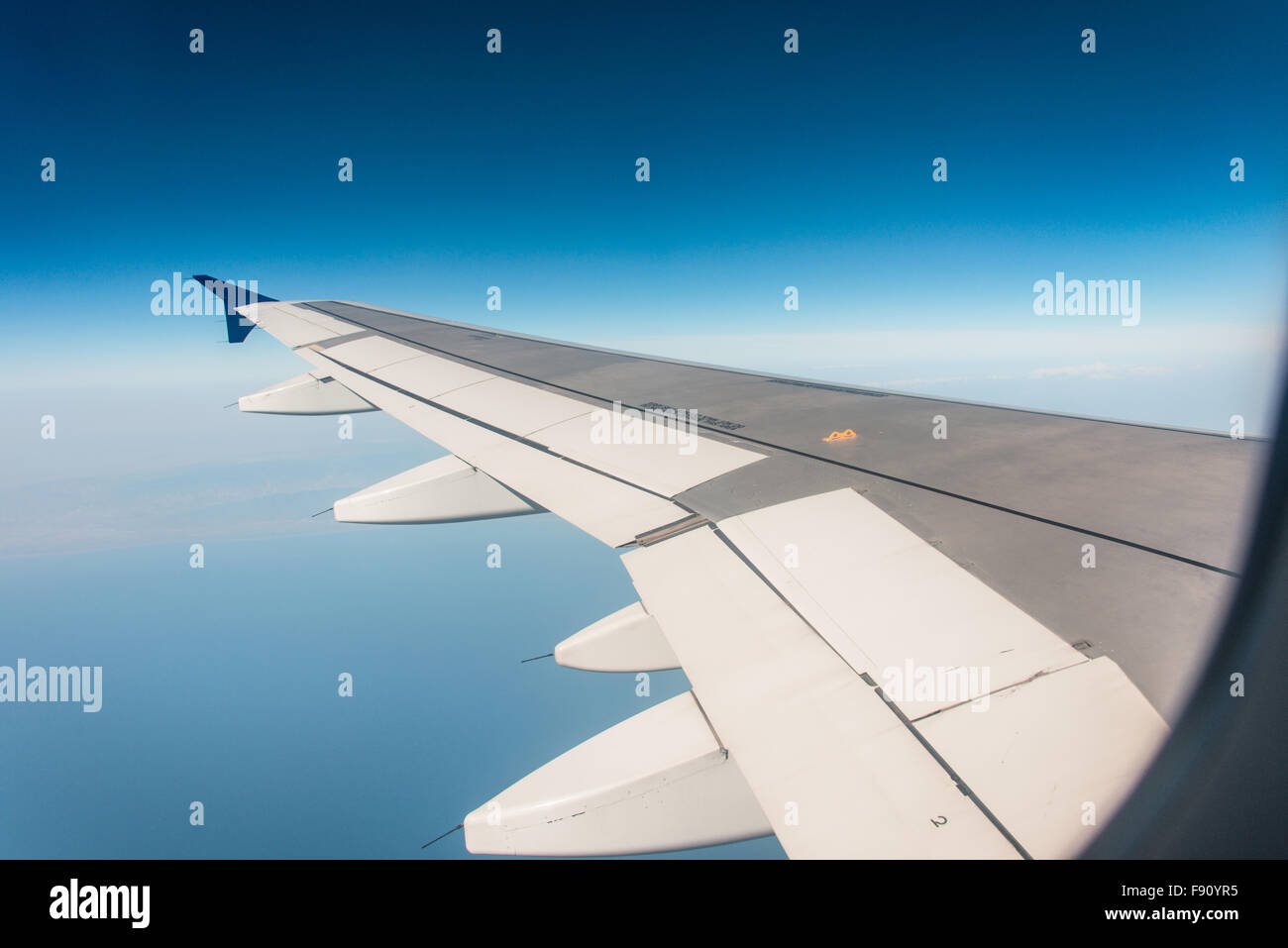 Airplane wing out of window Stock Photo - Alamy