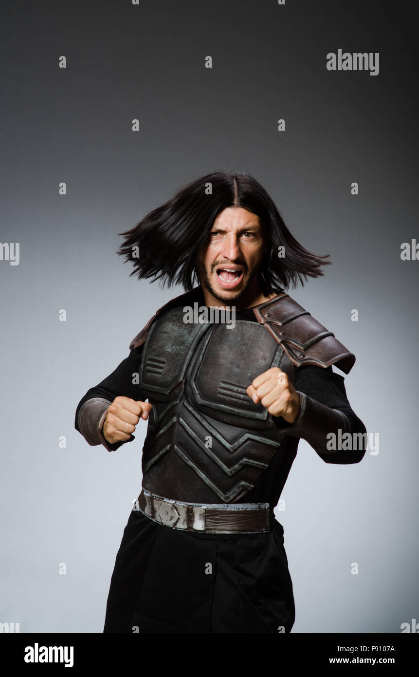 Angry warrior against dark background Stock Photo - Alamy