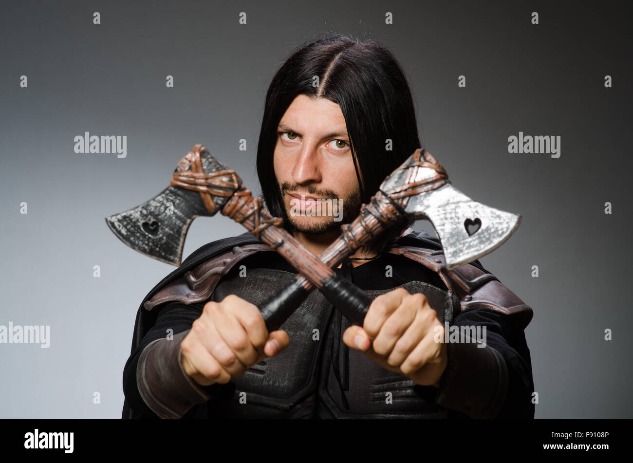 Knight with axe against dark background Stock Photo - Alamy