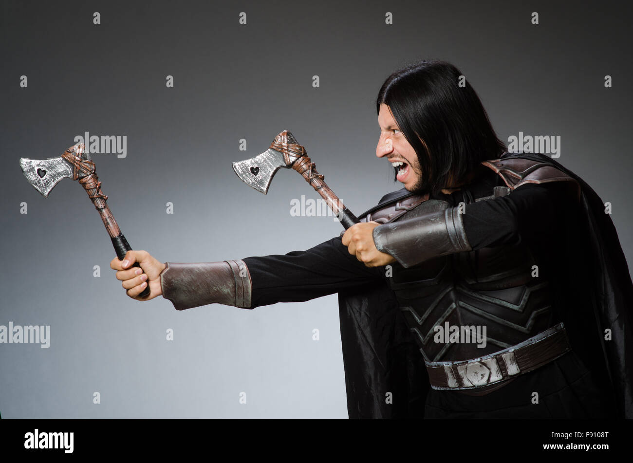 Knight with axe against dark background Stock Photo - Alamy
