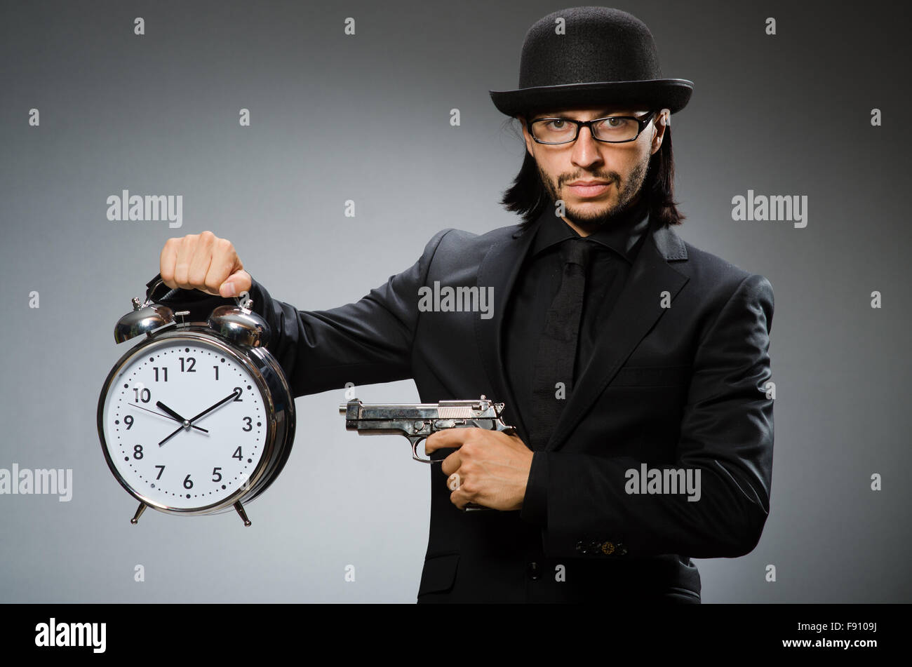 Man with clock wearing vintage hat Stock Photo - Alamy