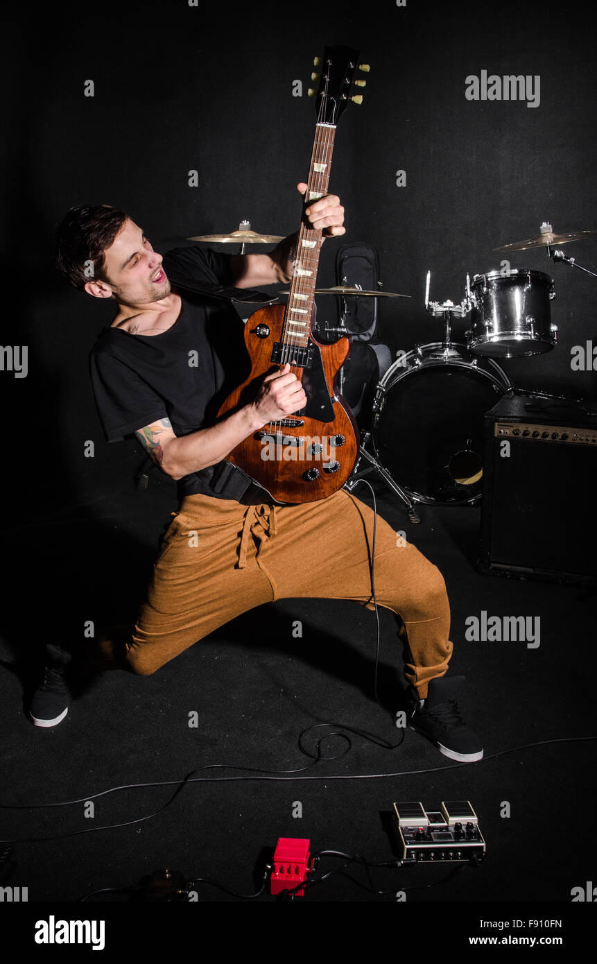 Man with guitar during concert Stock Photo - Alamy