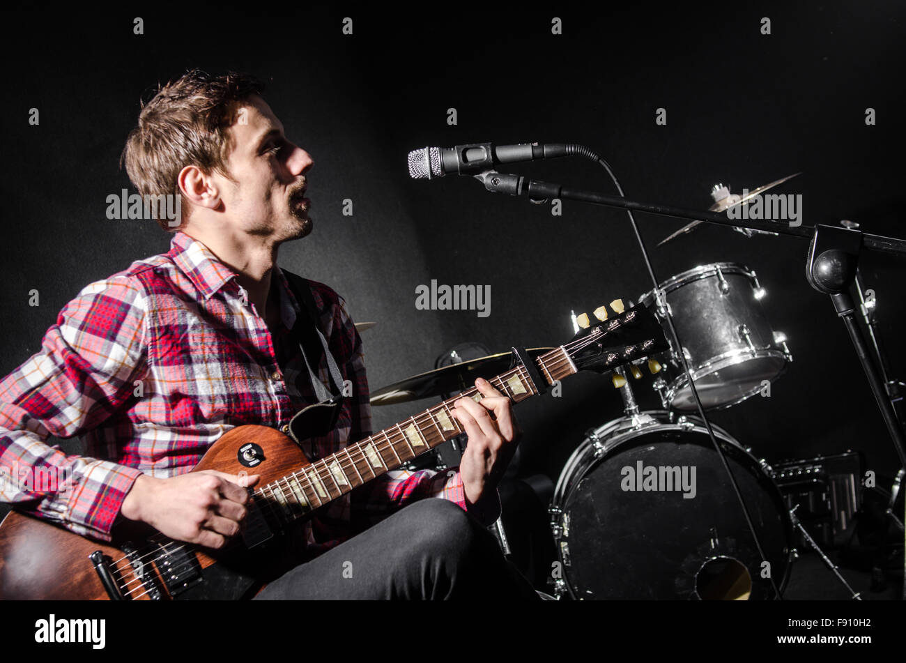 Man with guitar during concert Stock Photo - Alamy