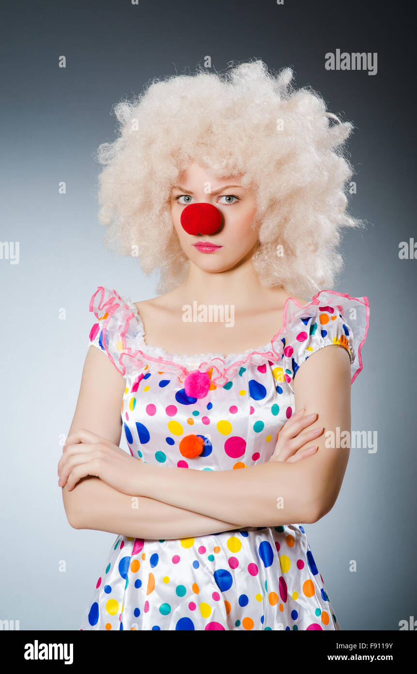 Clown with white wig against grey background Stock Photo - Alamy