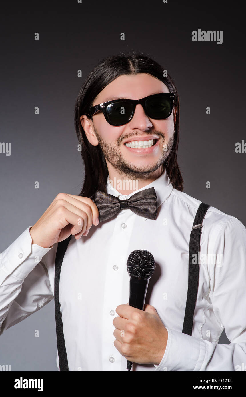 Funny singer with microphone at the concert Stock Photo - Alamy