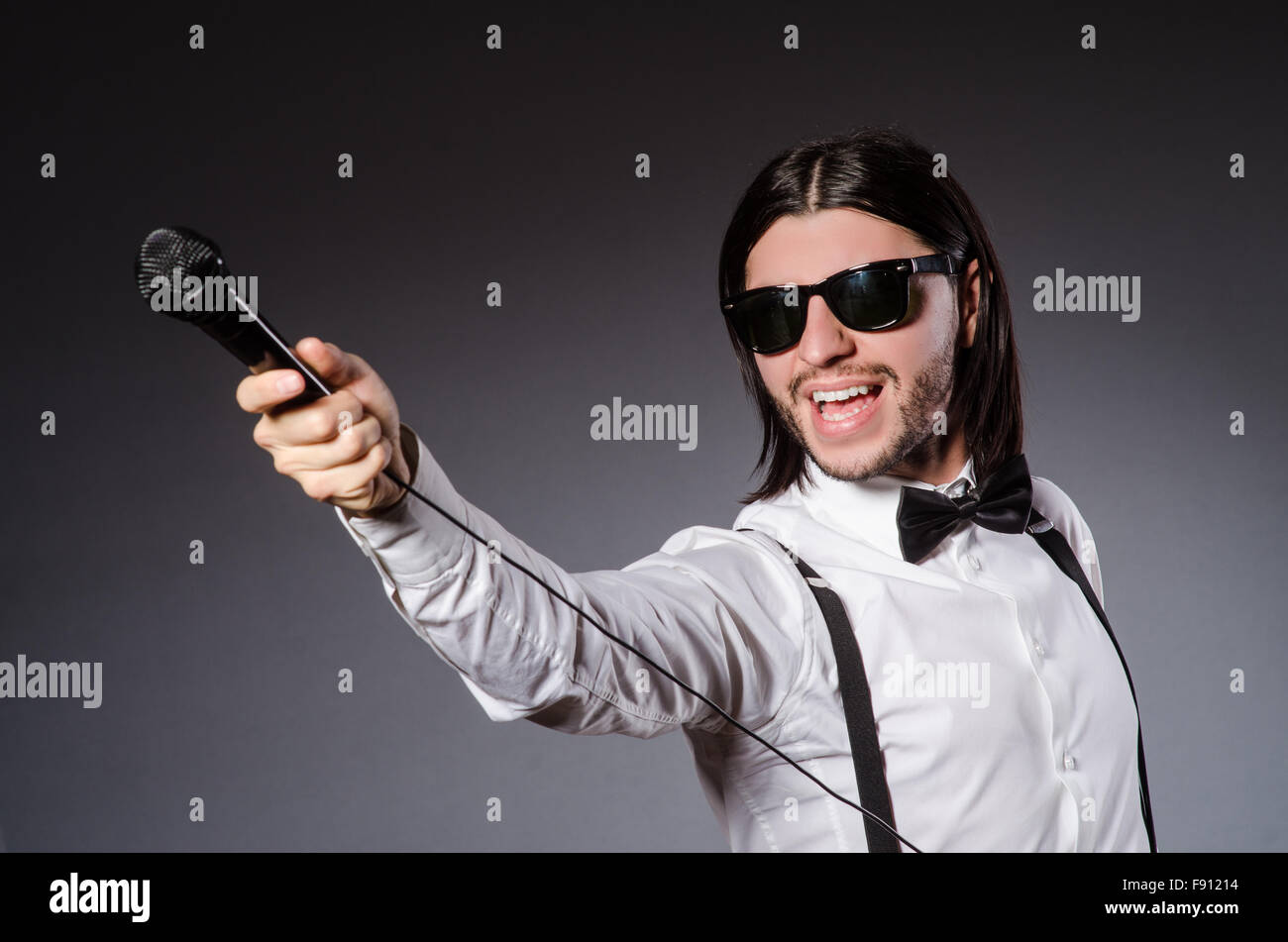Funny singer with microphone at the concert Stock Photo - Alamy