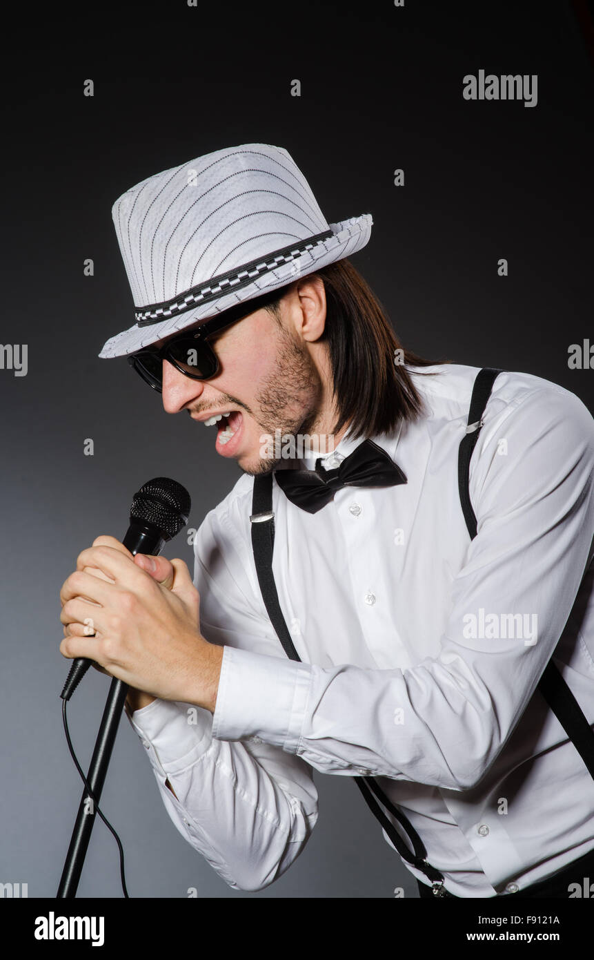 Funny singer with microphone at the concert Stock Photo - Alamy