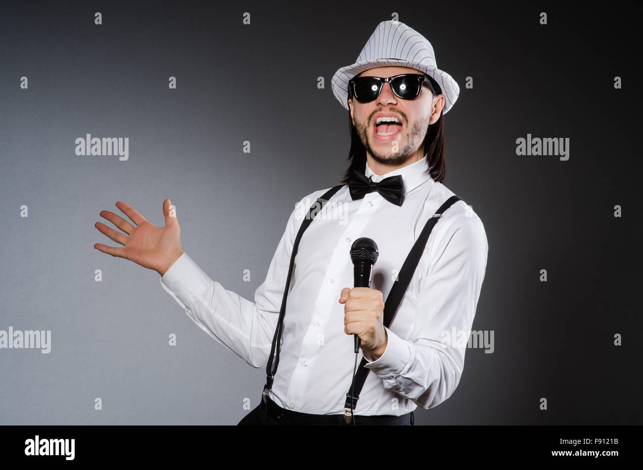 Funny singer with microphone at the concert Stock Photo - Alamy