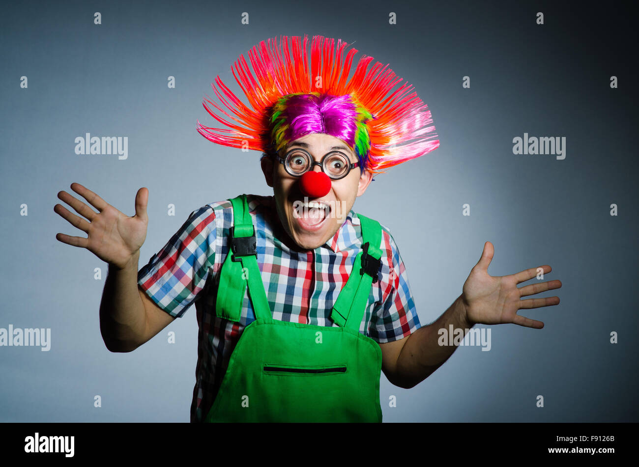 Funny clown against the grey background Stock Photo - Alamy