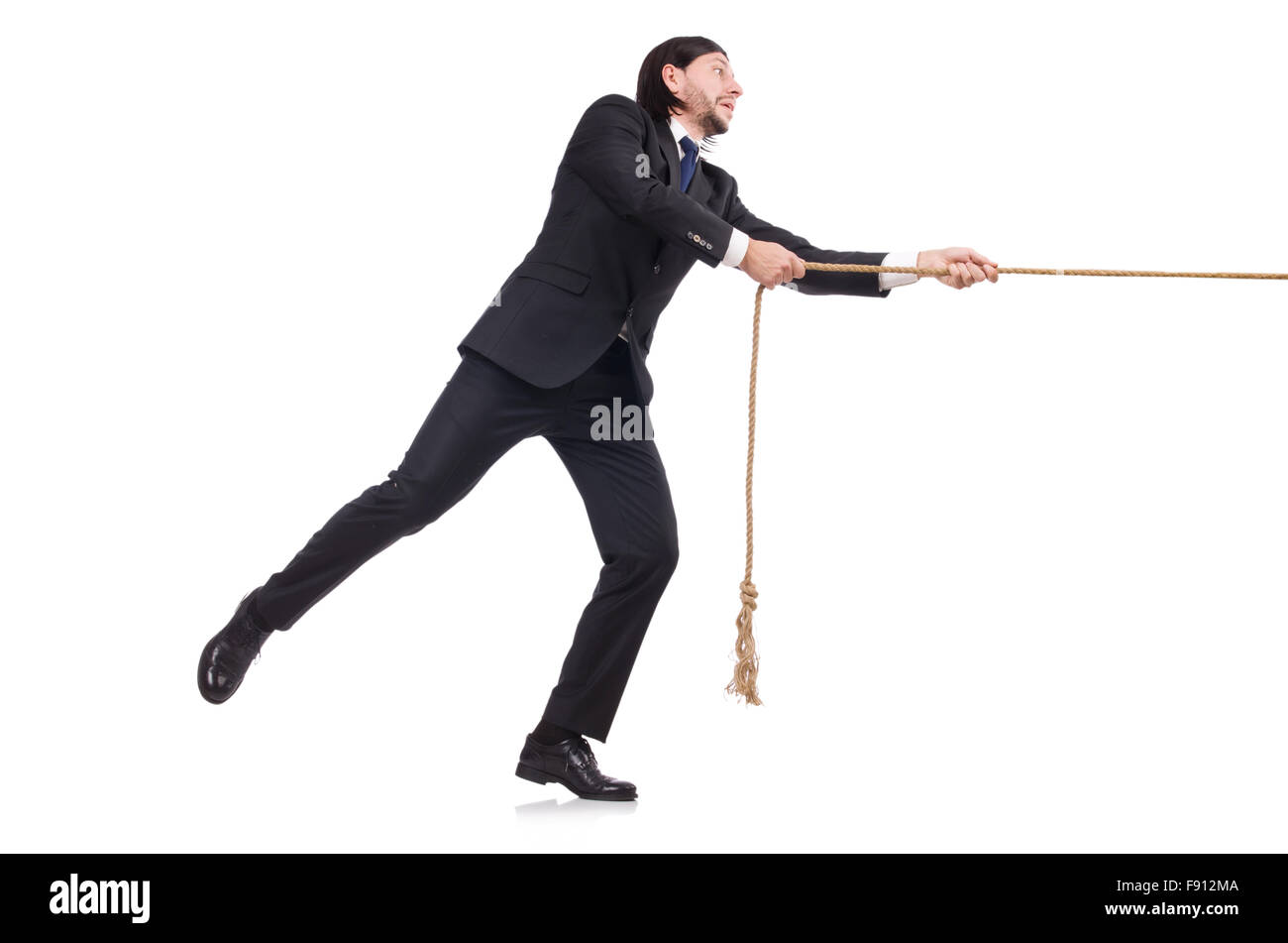Young businessman pulling rope isolated on white Stock Photo - Alamy