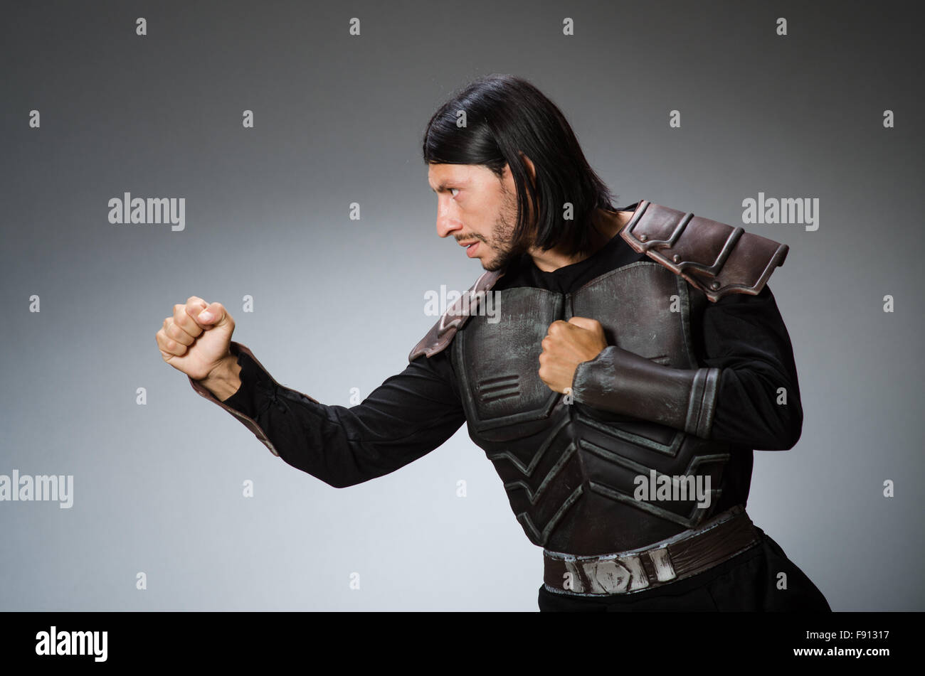 Angry warrior against dark background Stock Photo - Alamy