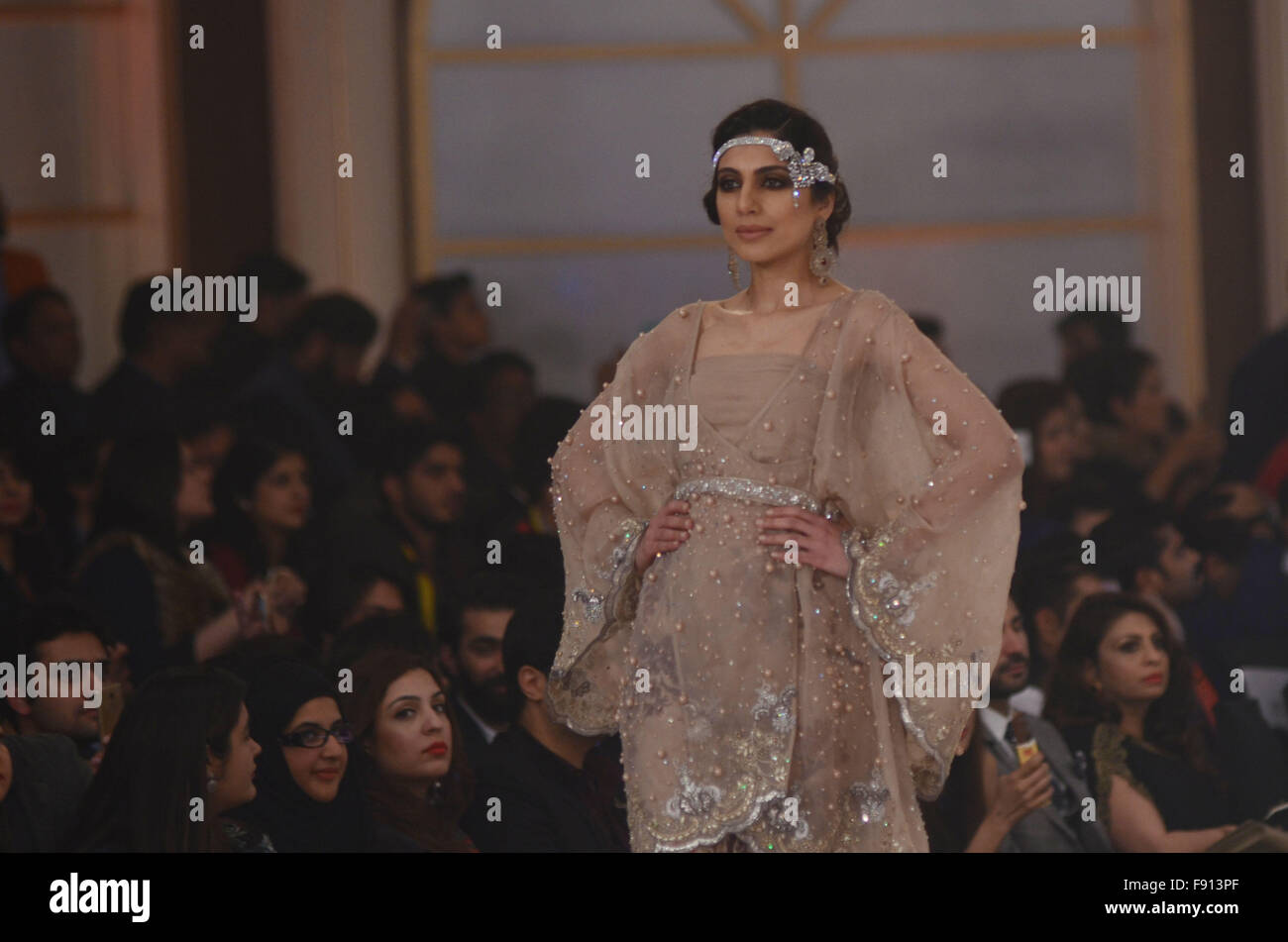 Lahore, Pakistan. 12th Dec, 2015. Pakistani model presents creations of ...