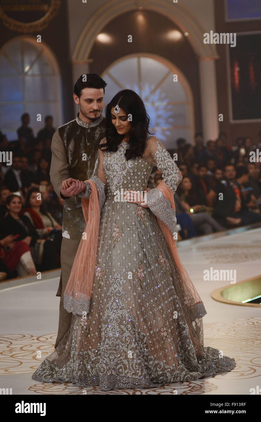 Lahore, Pakistan. 12th Dec, 2015. Pakistani models present creations of ...