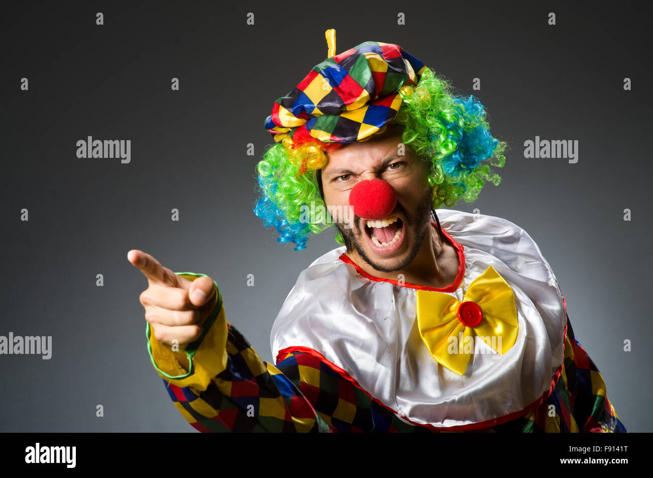 Funny clown in colourful costume Stock Photo - Alamy