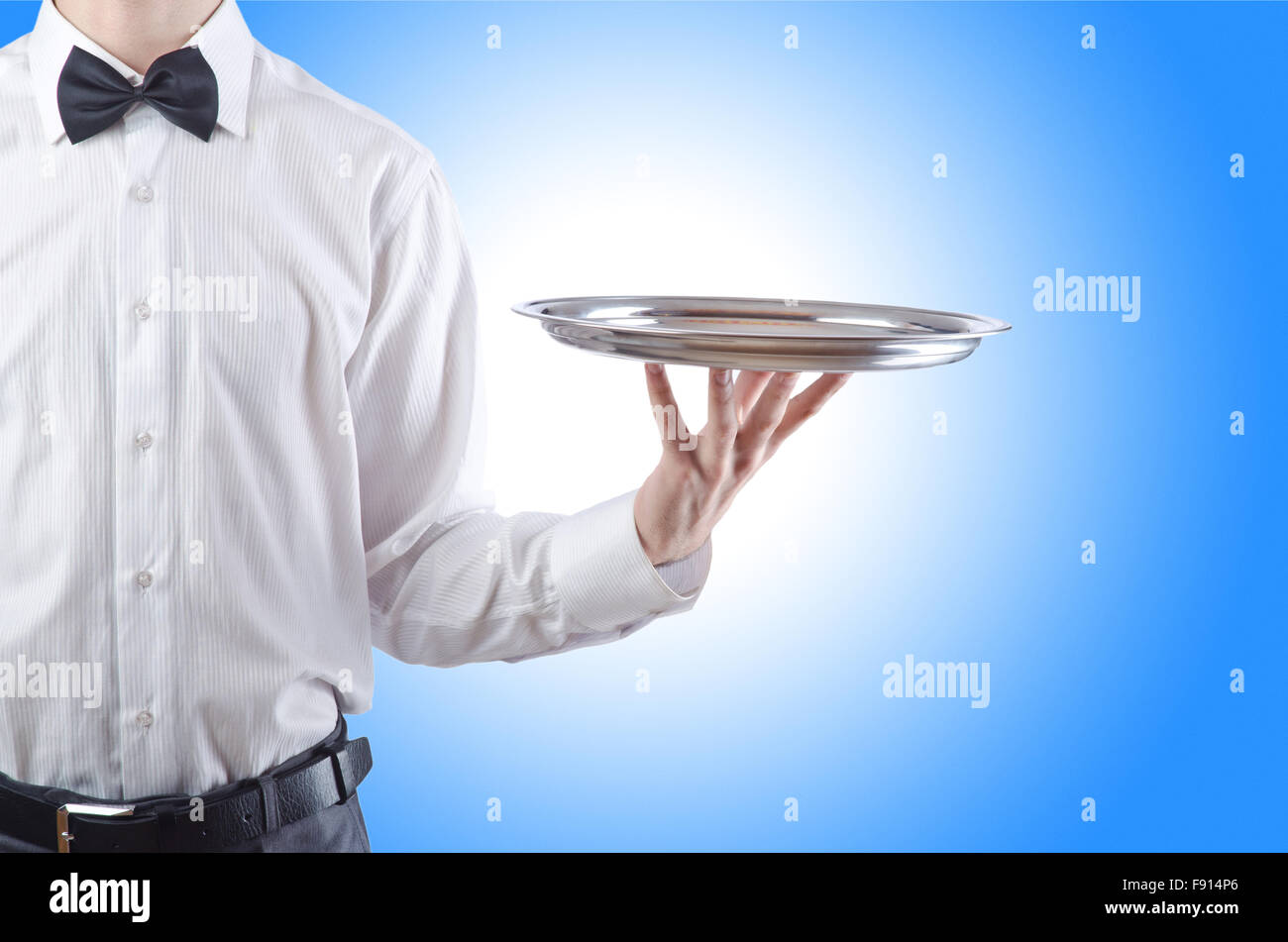Young waiter with silver tray Stock Photo - Alamy