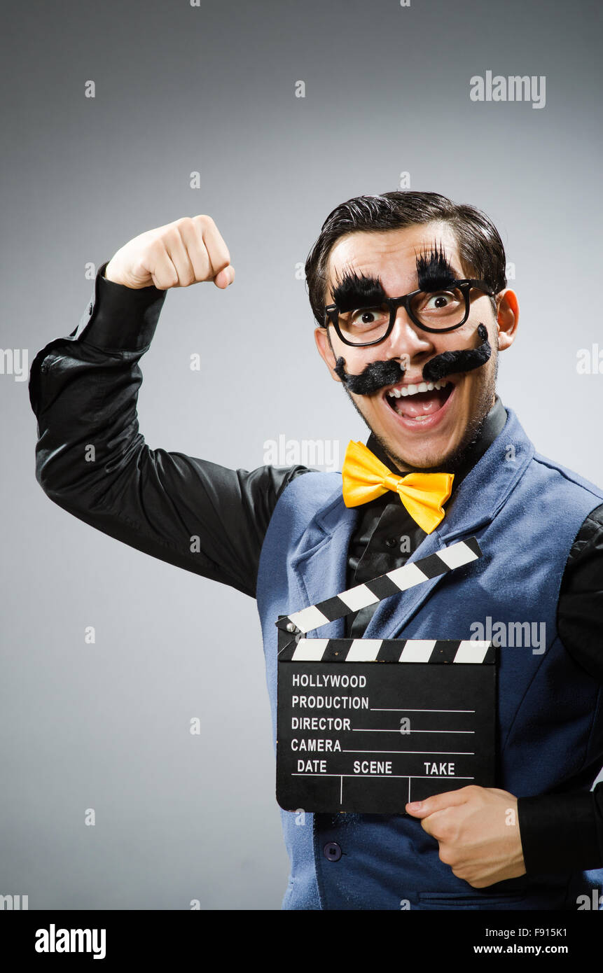 Funny man holding movie clapper Stock Photo - Alamy