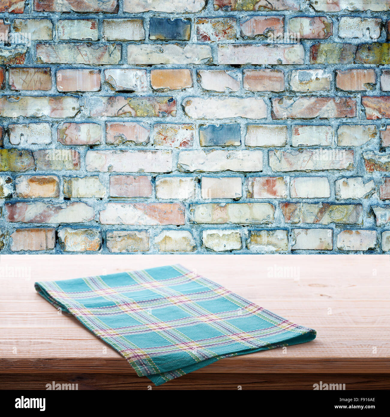 Empty table and tablecloth, gray brick wall as background, for product ...