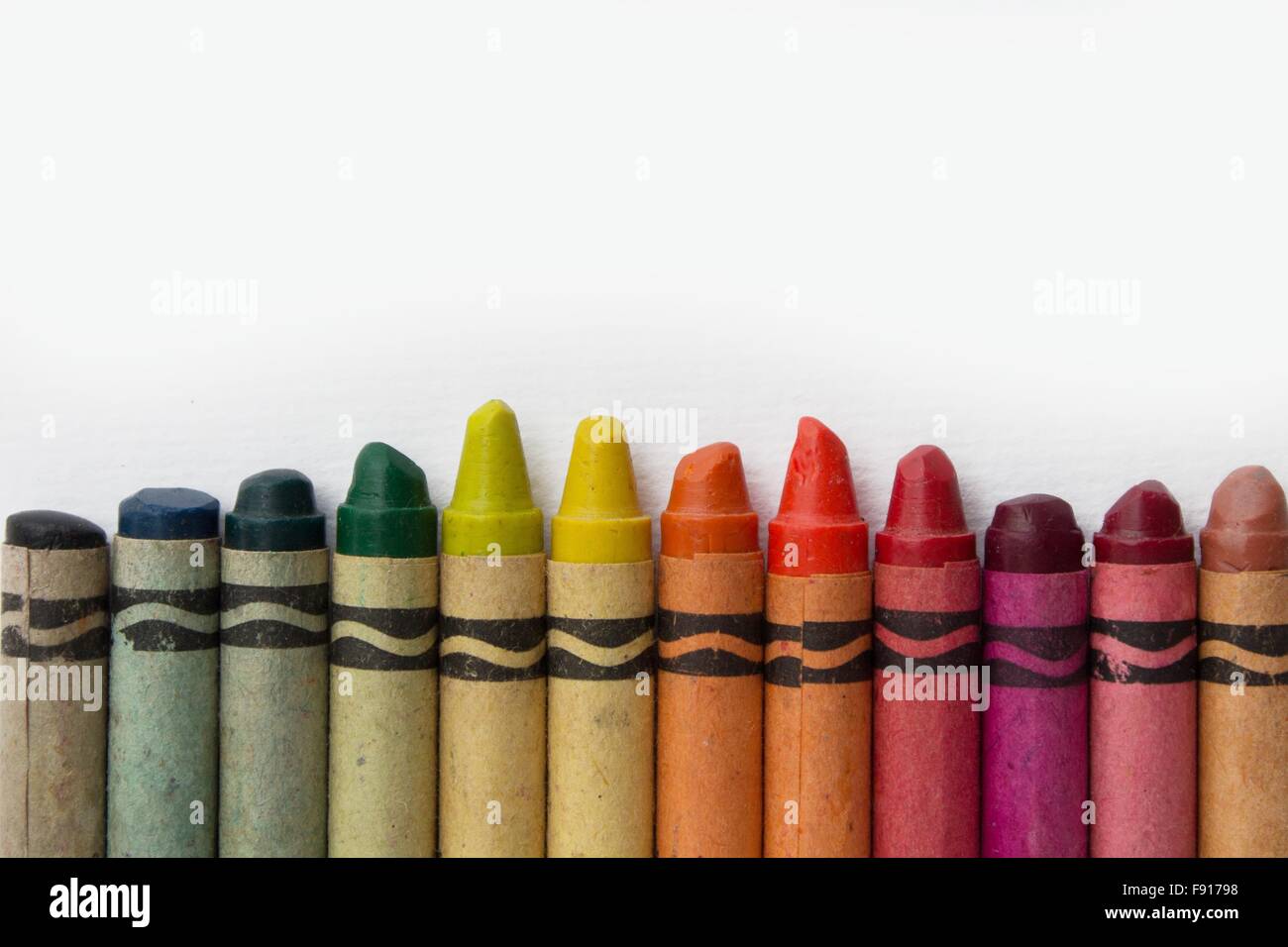 group of old wax crayons on white paper - vintage crayons many colors ...