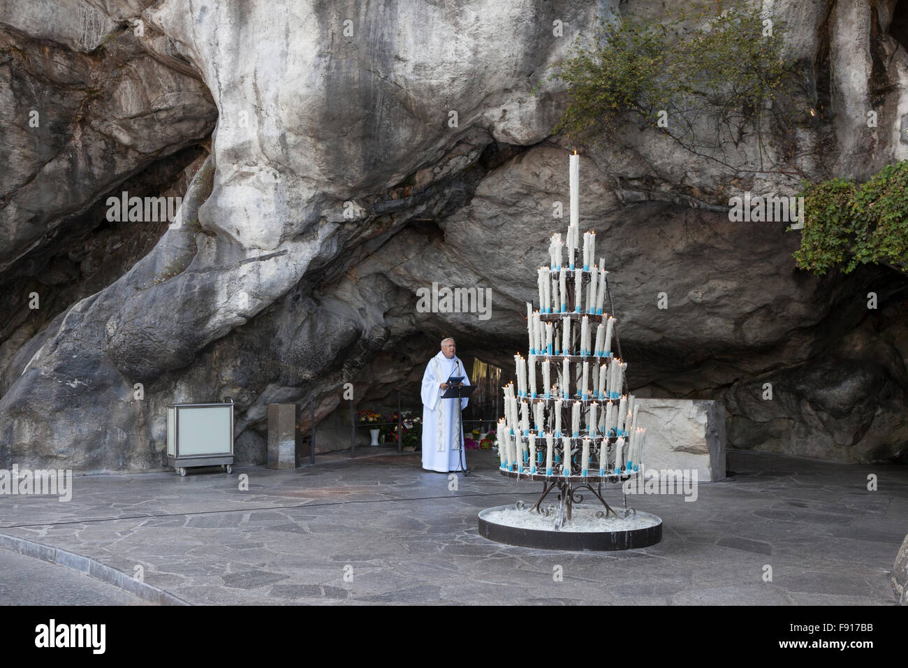 Priest saying mass at the Grotto of Massabielle in the Sanctuary of Our ...