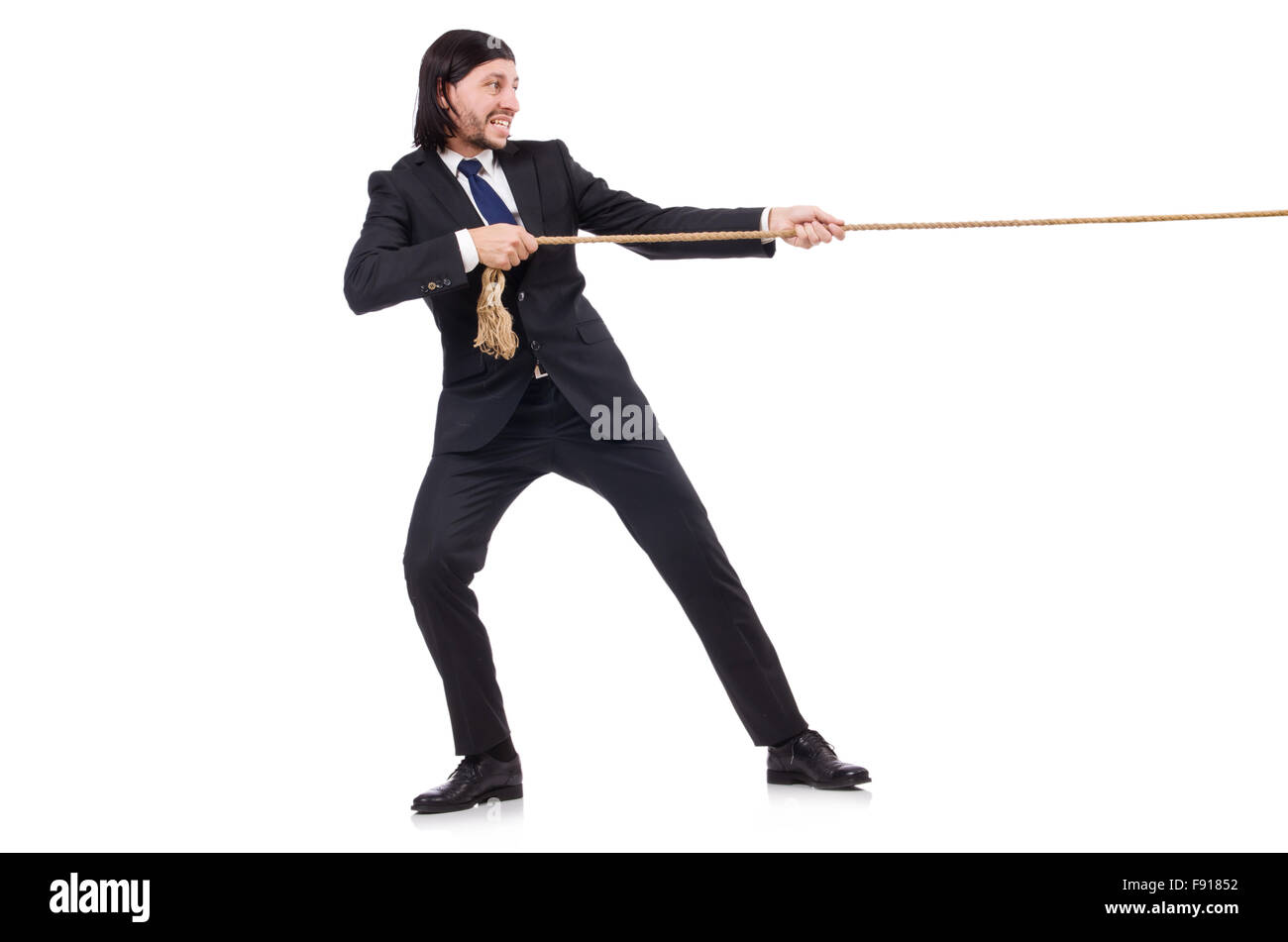 Young businessman pulling rope isolated on white Stock Photo - Alamy