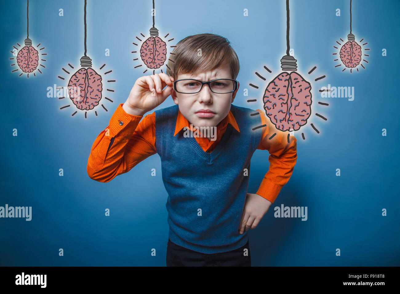 adolescent boy holds hand glasses leaned forward peering brain b Stock ...