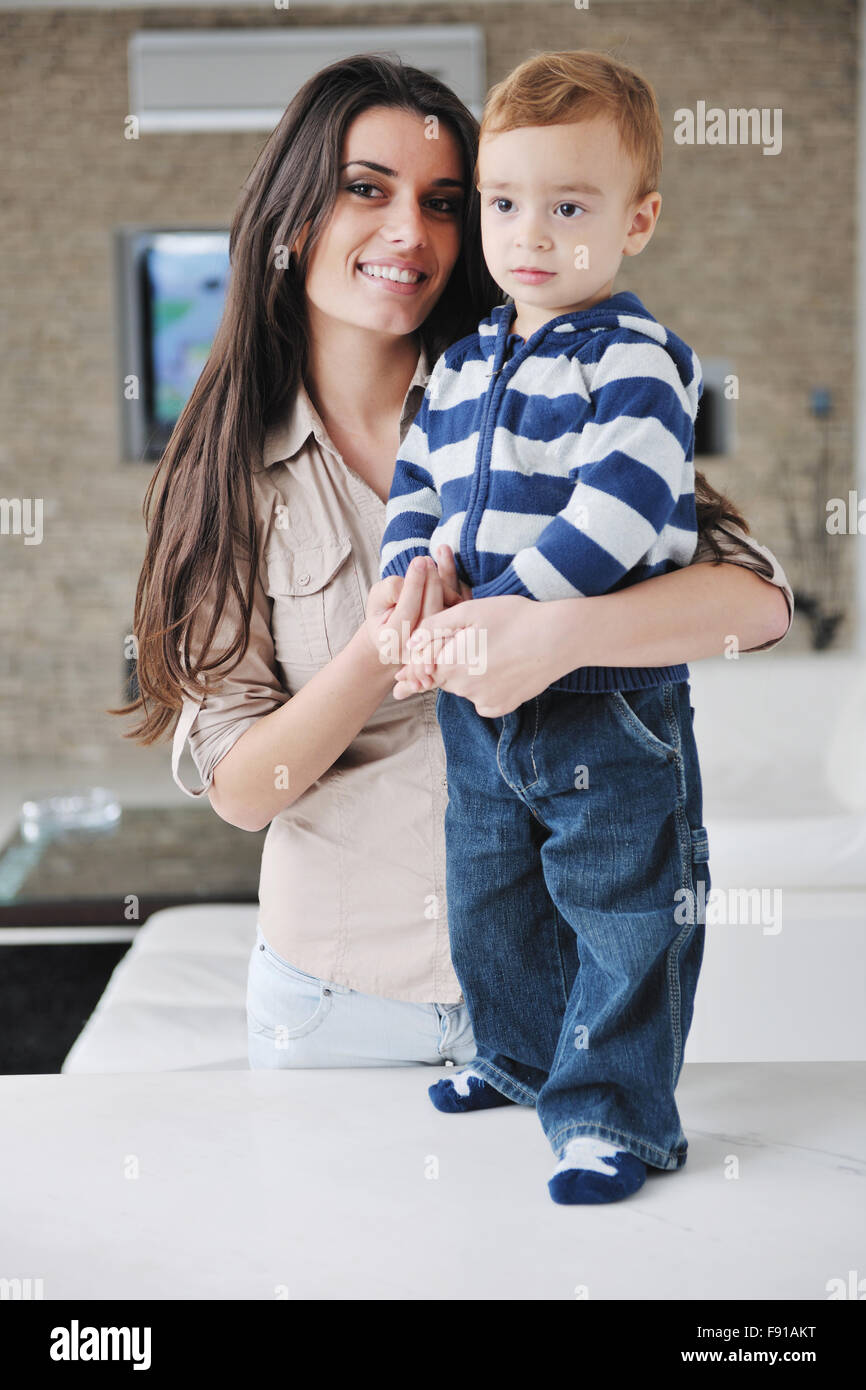 portrait of a happy mom and son together in modern living room home ...